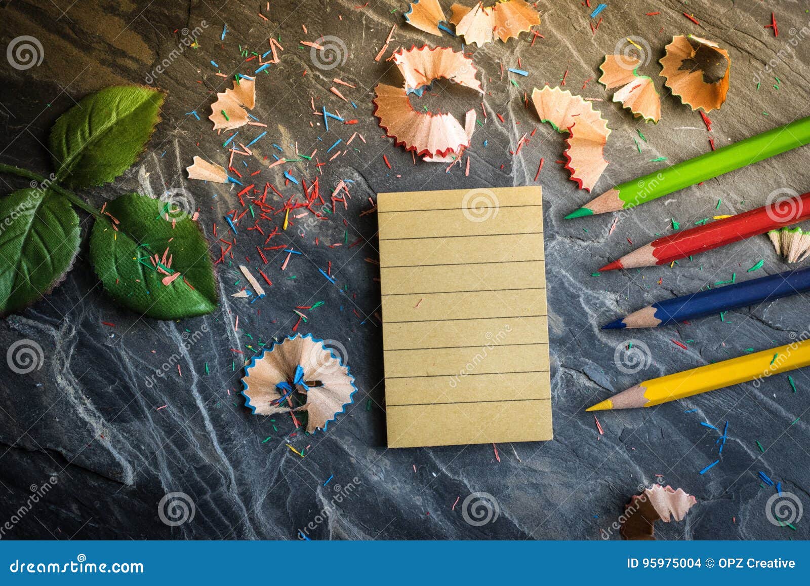 A Notebook for Notes with Crayons and Pencils. Pencil Sharpener Placed ...