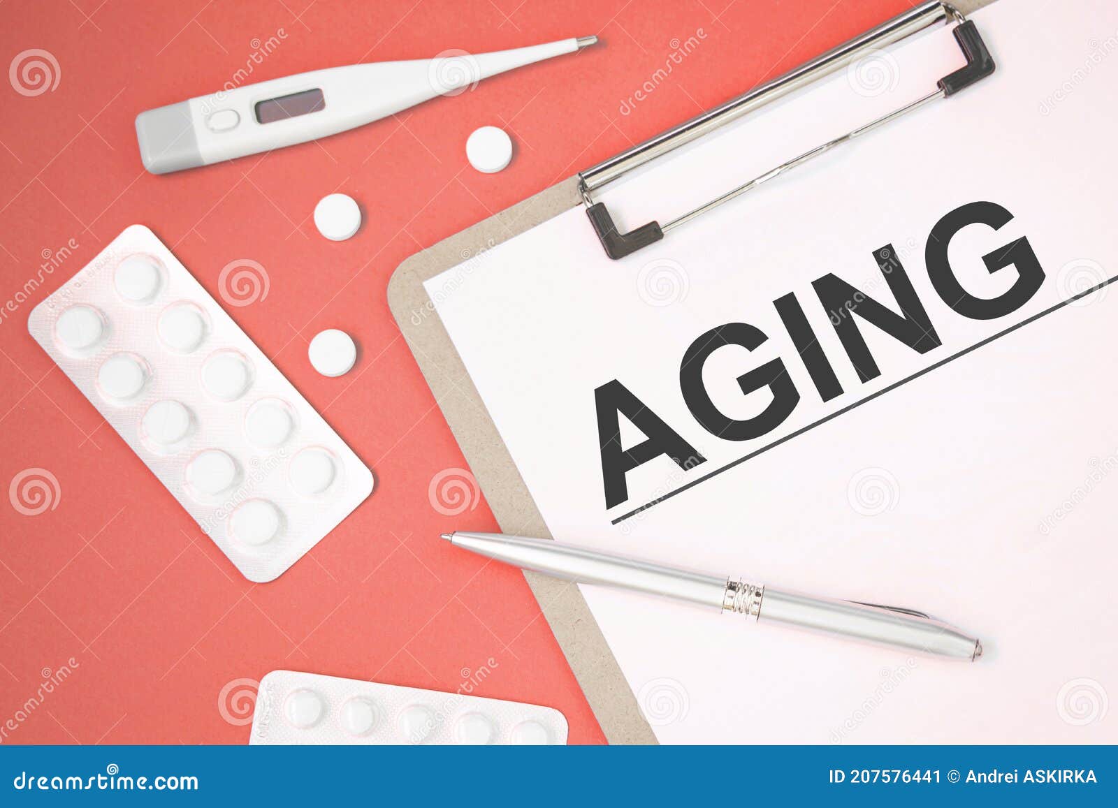 Notebook Page with Text AGING on a Table with a Pills and Pencil ...