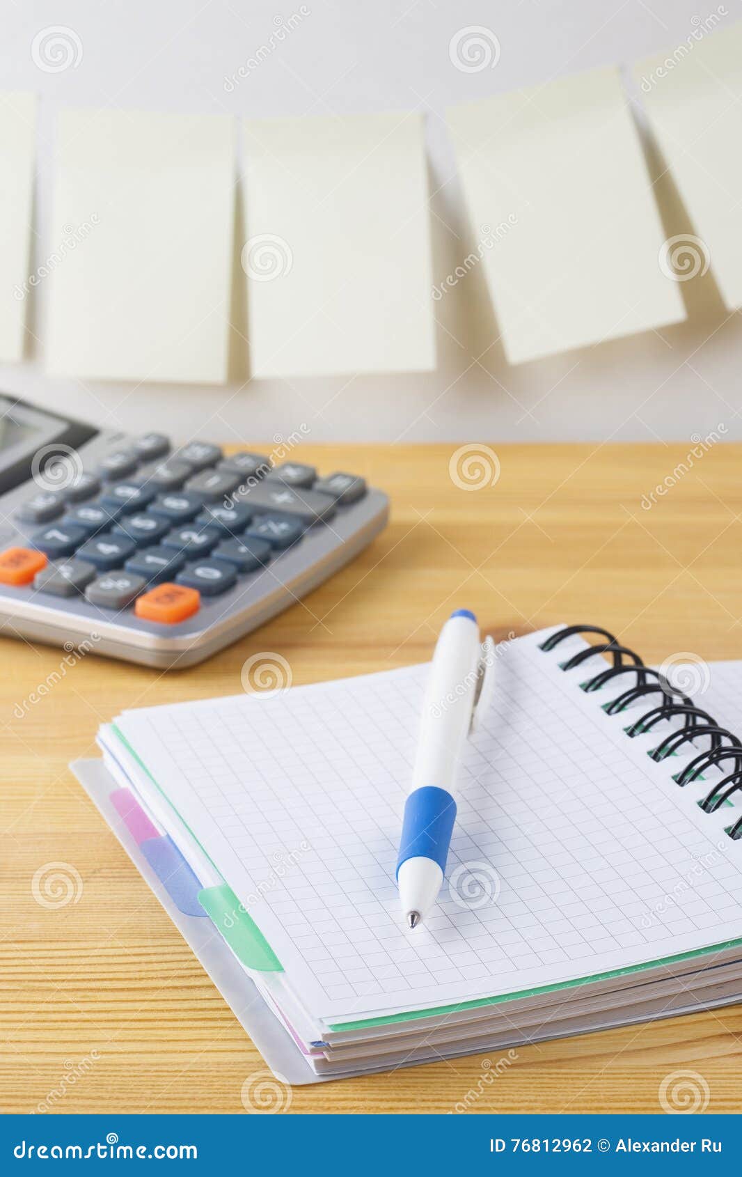 Notebook with Pen, Calculator are on a Wooden Table. on the Wall Near ...