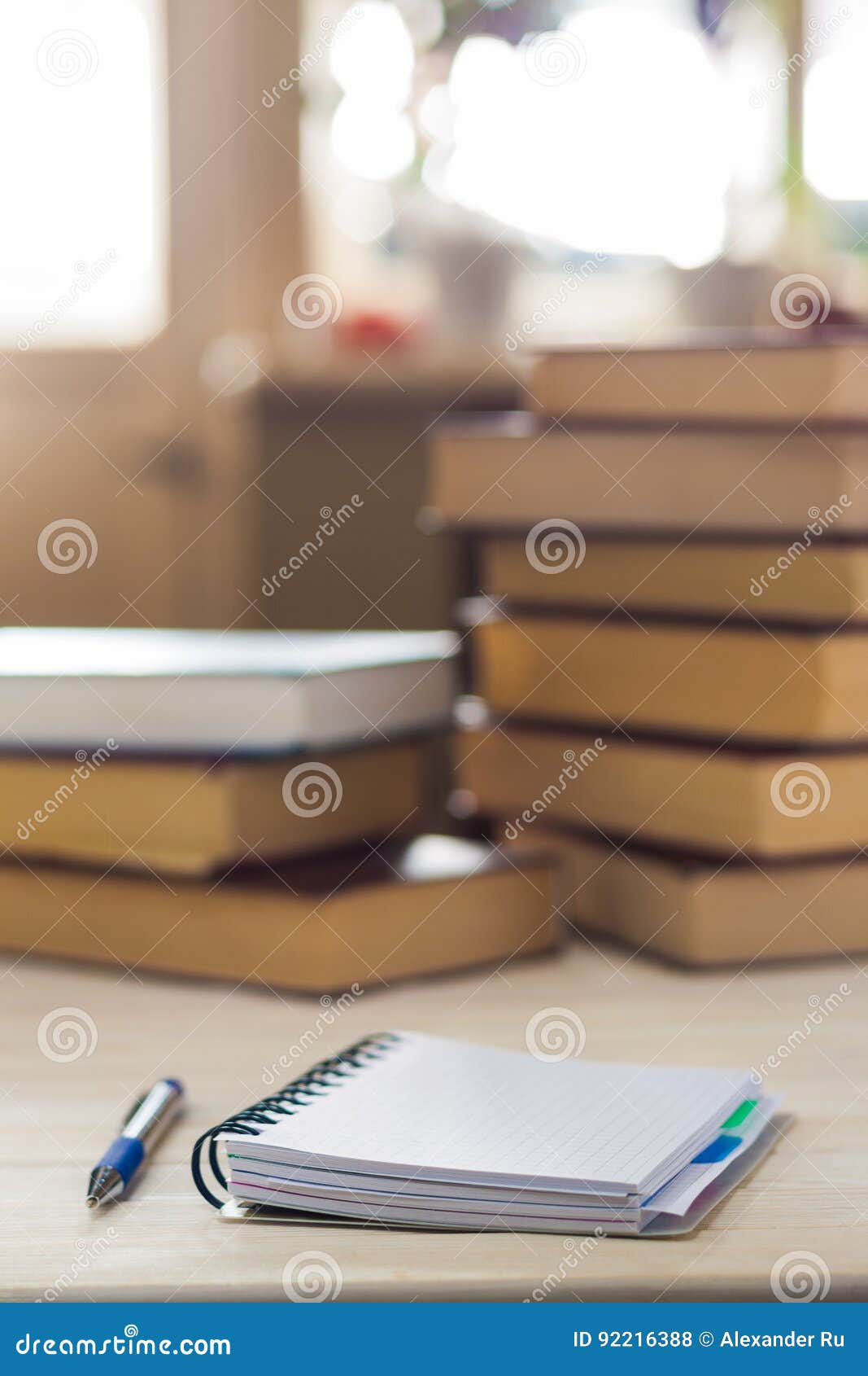 Notebook with Pen on a Wooden Table in Front of the Window. a Stack of ...