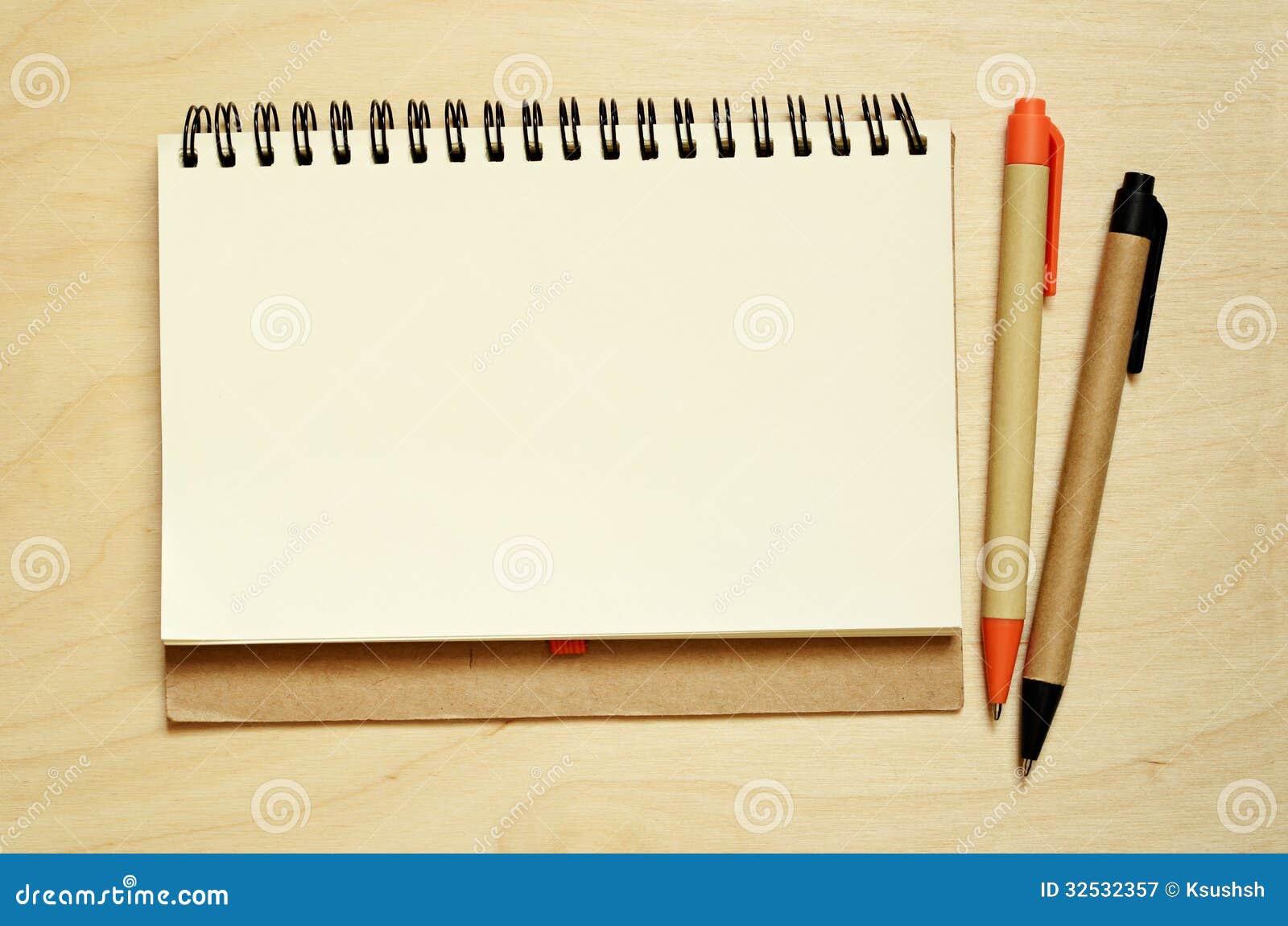 Notebook and pens on desk stock image. Image of pens - 32532357