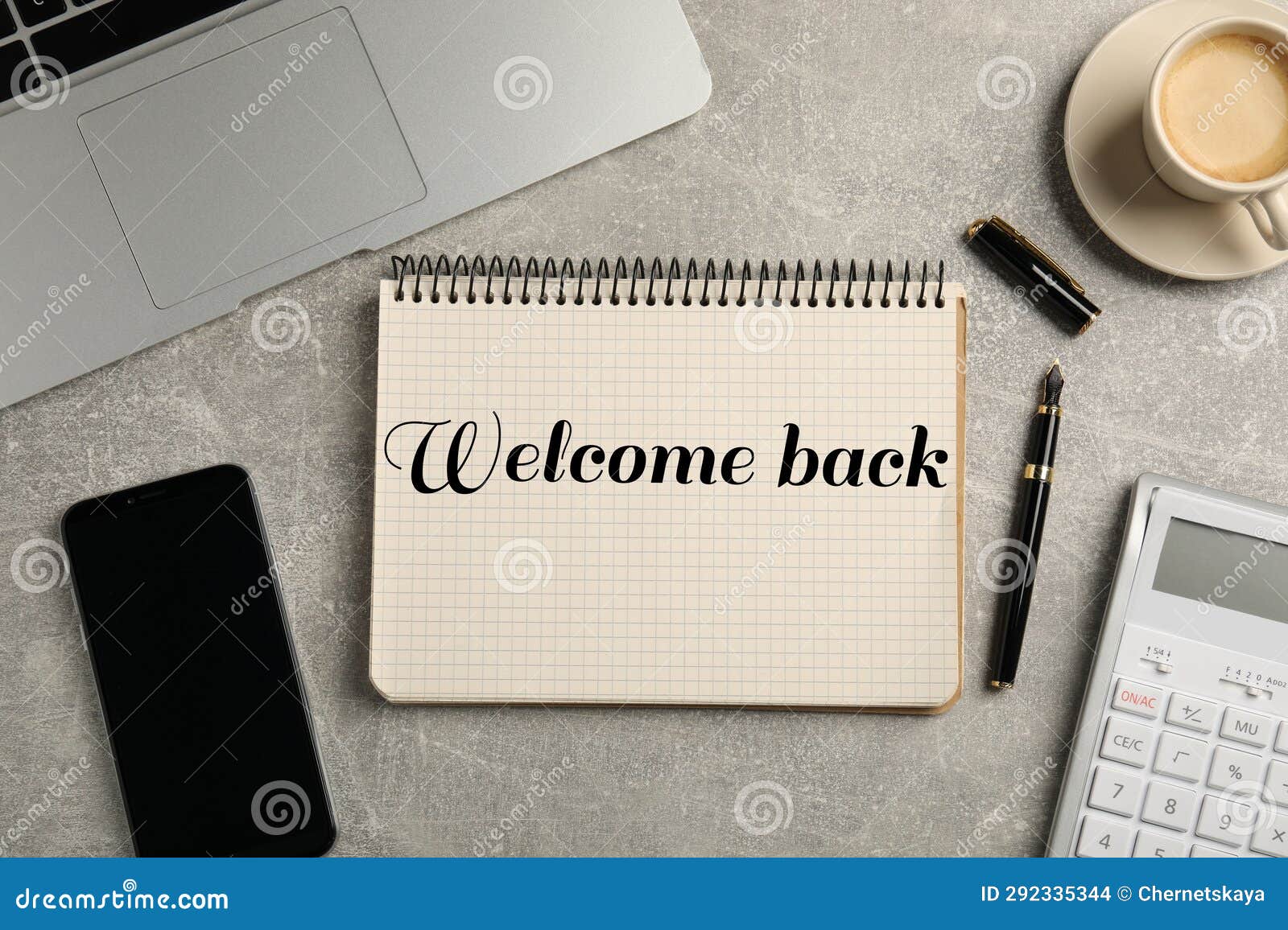 Notebook with Phrase Welcome Back on Grey Table. Office Desk with ...
