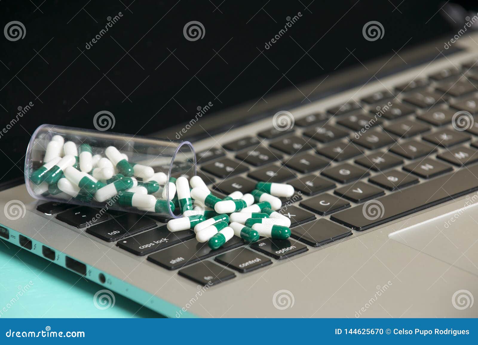 Notebook and pills stock photo. Image of treatment, laptop - 144625670