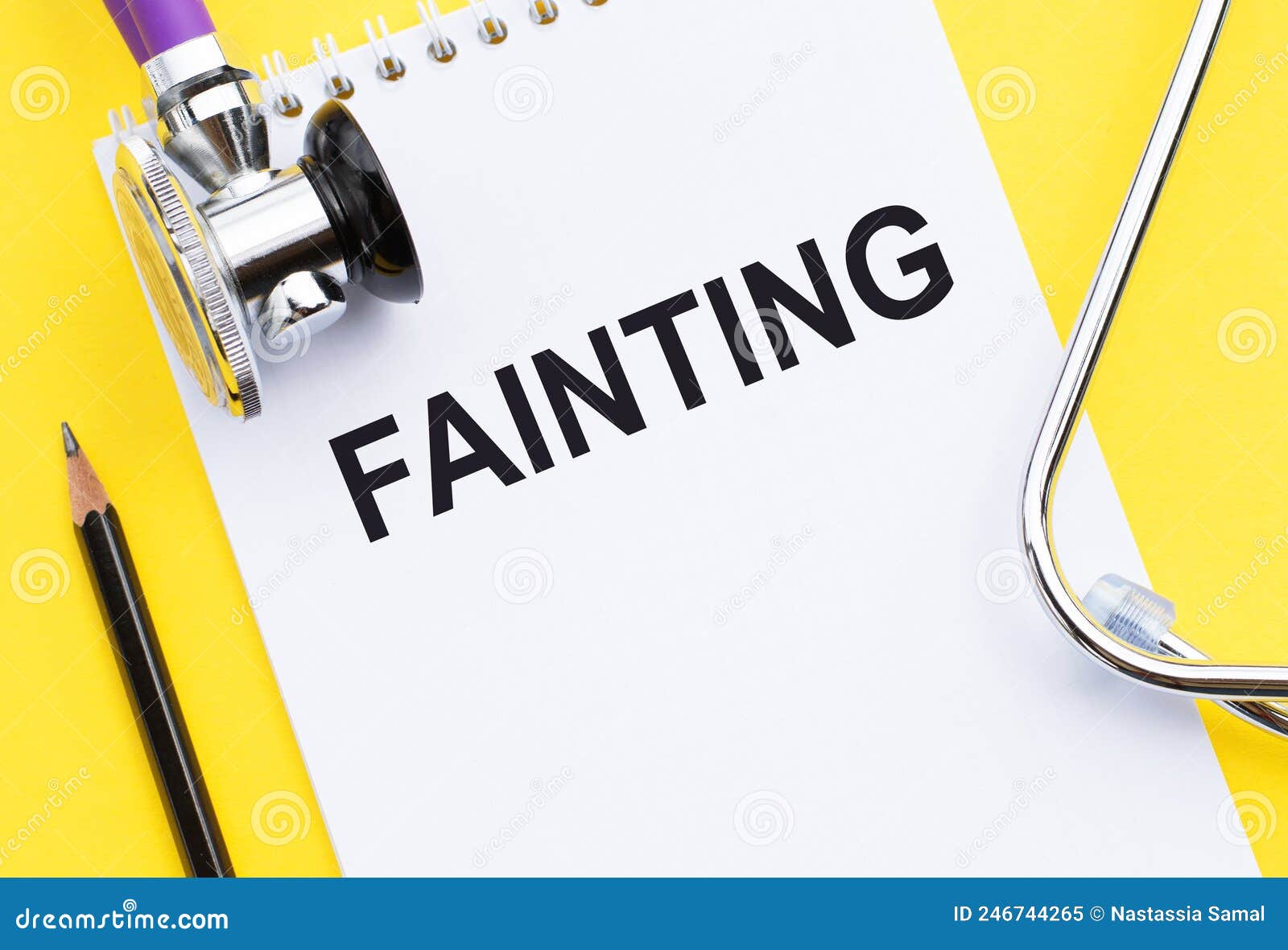 In the Notebook is the Text FAINTING, Next To the Stethoscope and Black ...