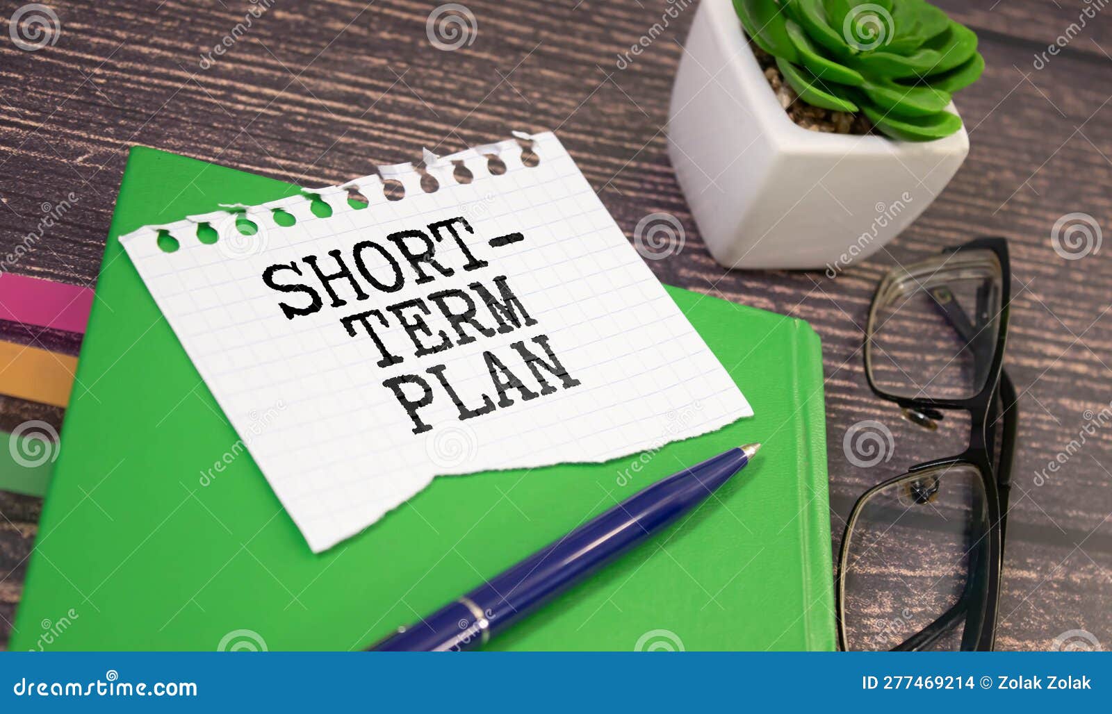 Notebook with Text SHORT-TERM PLAN on a Table with Charts,pen and ...