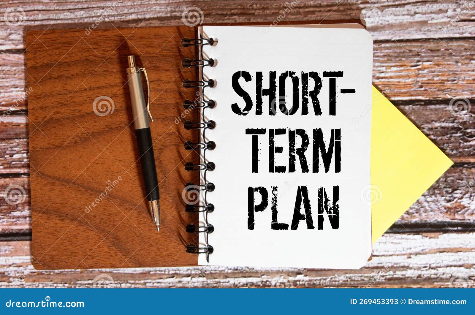 Notebook with Text SHORT-TERM PLAN on a Table with Charts,pen and ...