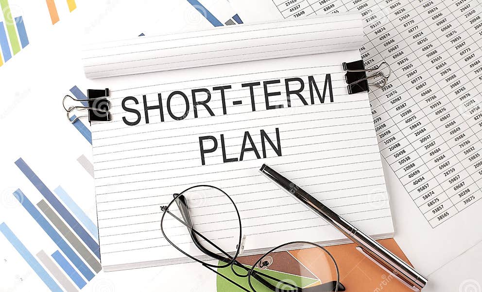 Notebook with Text SHORT-TERM PLAN on Table with Charts,pen and Glasses ...