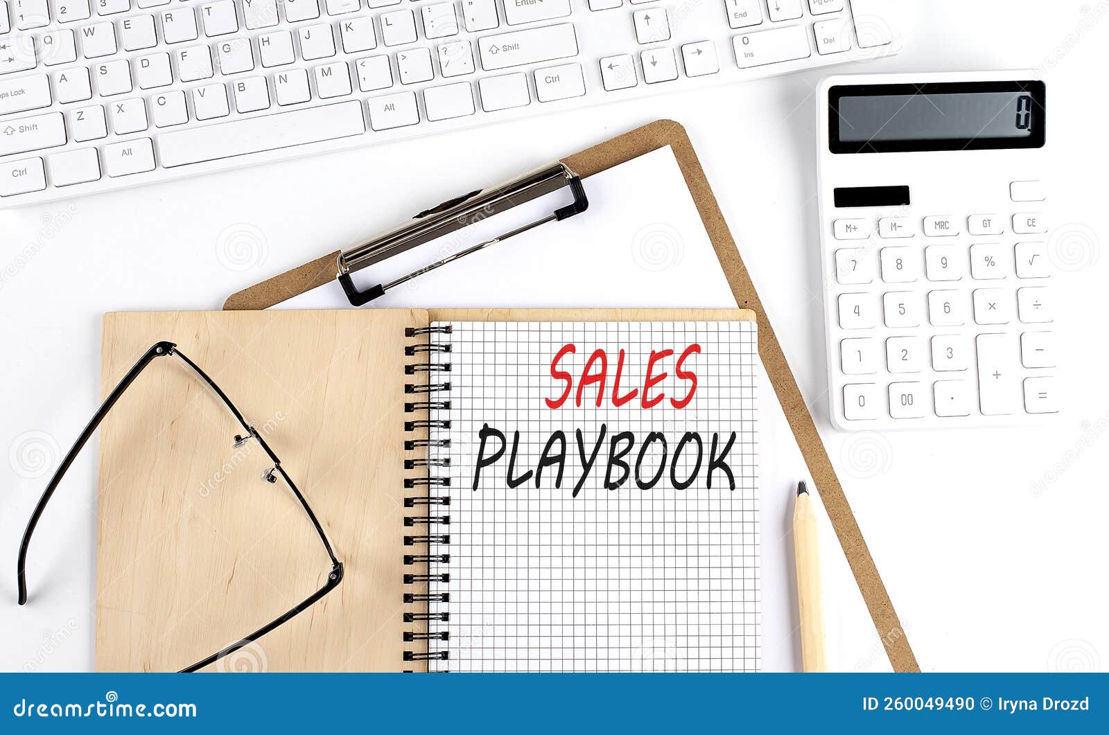Notebook with the Word SALES PLAYBOOK Nd Calculator on the White ...