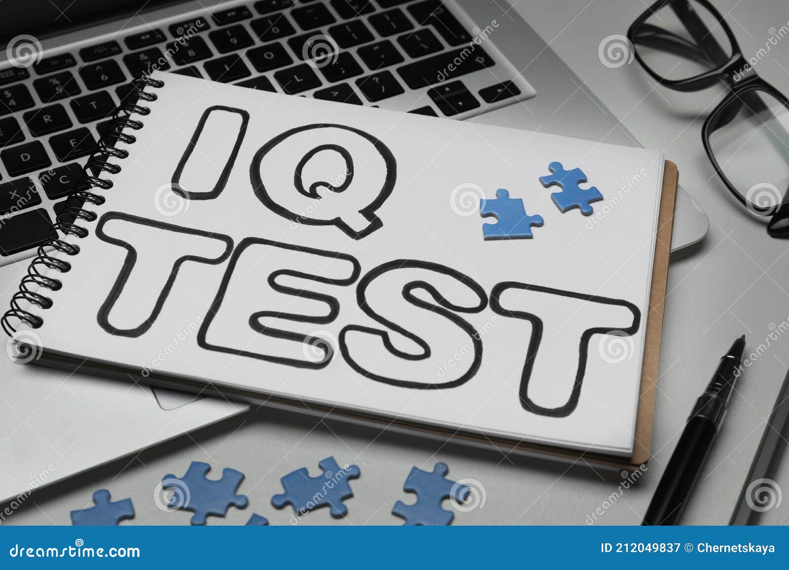 Notebook with Words IQ Test, Puzzles and Laptop on White Table Stock ...