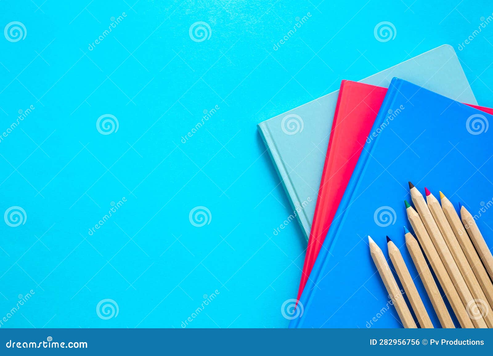 Notebooks and Pencils on a Blue Background, Top View. Stock Photo ...