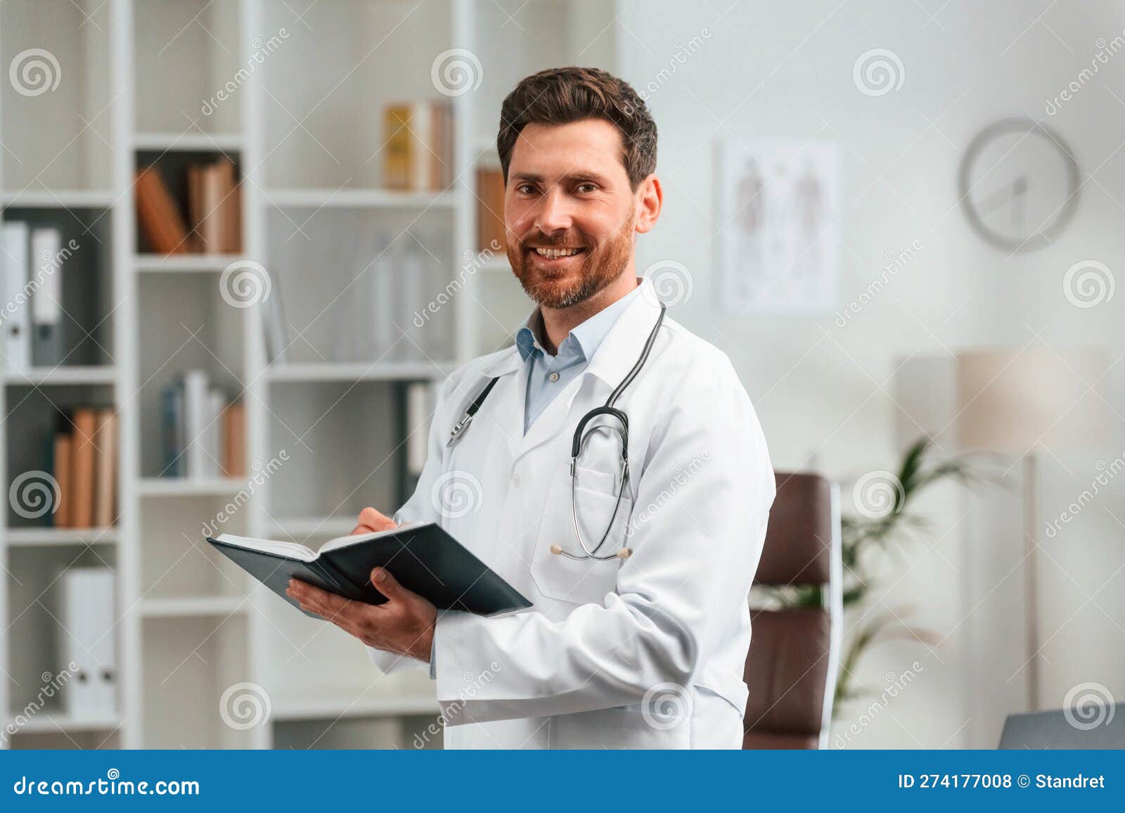 With Notepad. Doctor in Formal Clothes is Working in the Cabinet Stock ...