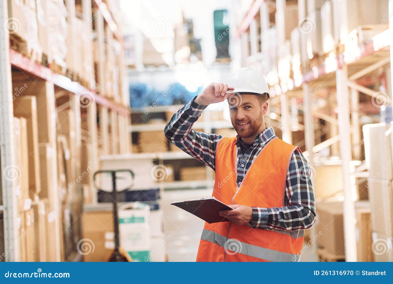 With Notepad. Employee in Uniform is Working in the Storage at Daytime ...