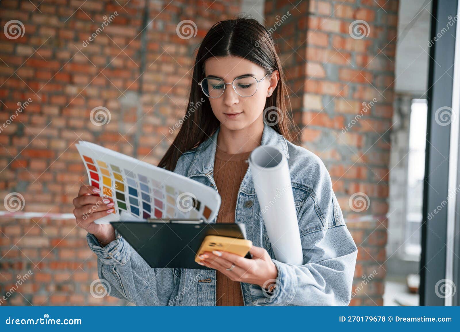 Notepad in Hands. Young Woman is Standing in the Unfinished Building on ...