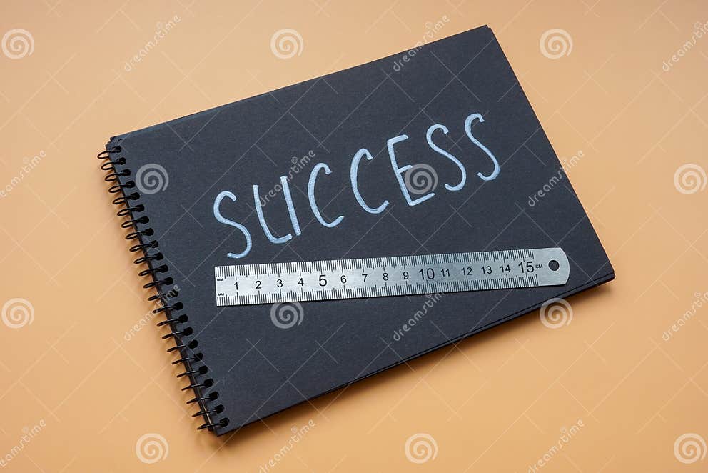 Notepad with the Inscription Success and a Ruler for Measuring it ...