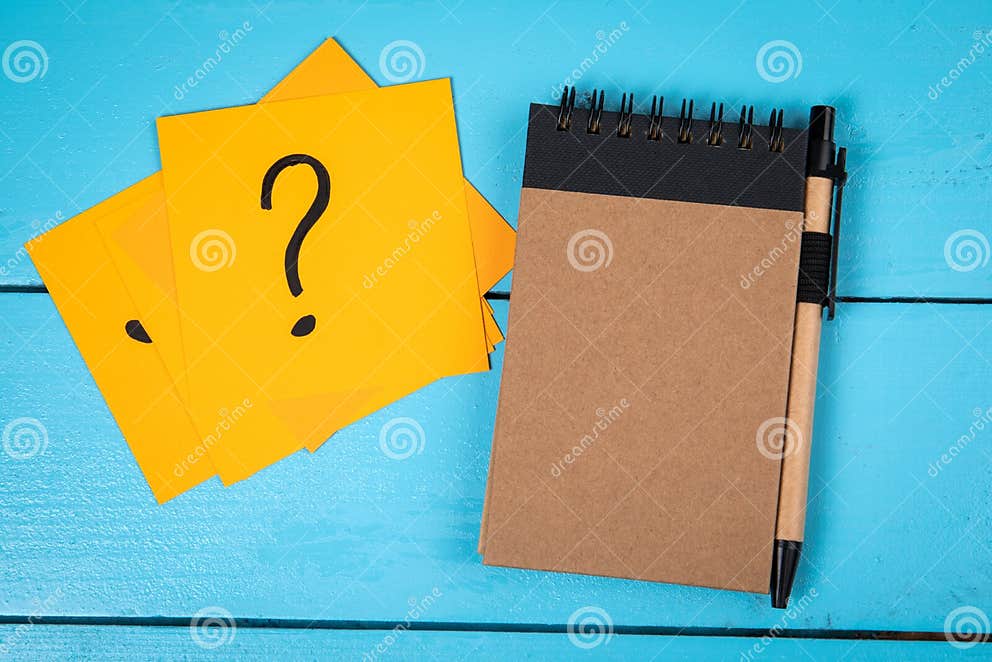 Notepad and Note Papers with Question Marks. Blue Board Table Stock ...
