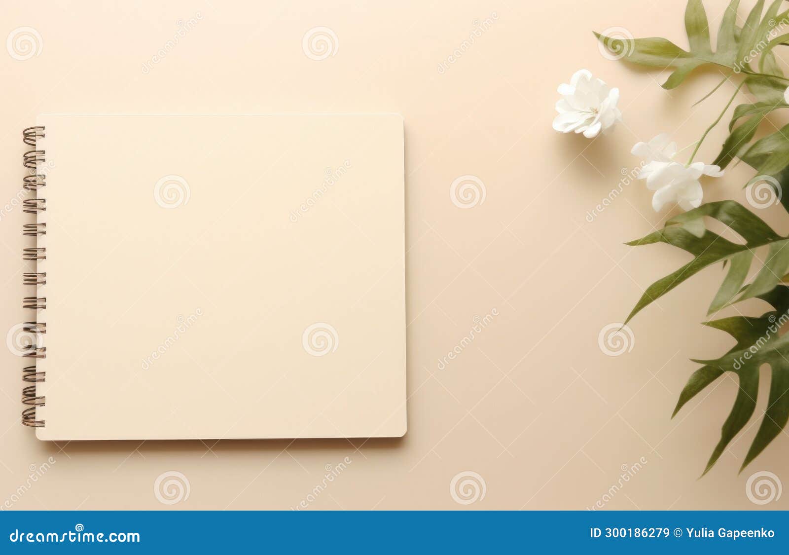 A Notepad, Notebooks and a Computer on a Beige Surface Stock ...