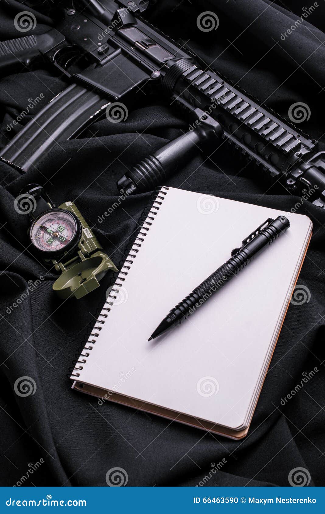 Notepad with Pen on Black Cloth with Rifle and Compass Stock Photo ...