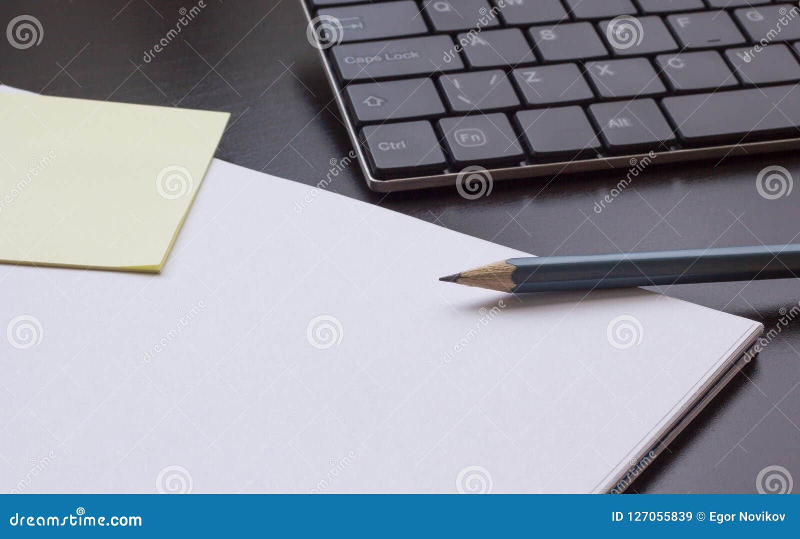 Notepad with a Pencil on the Table Next To the Keyboard, Close-up Stock ...