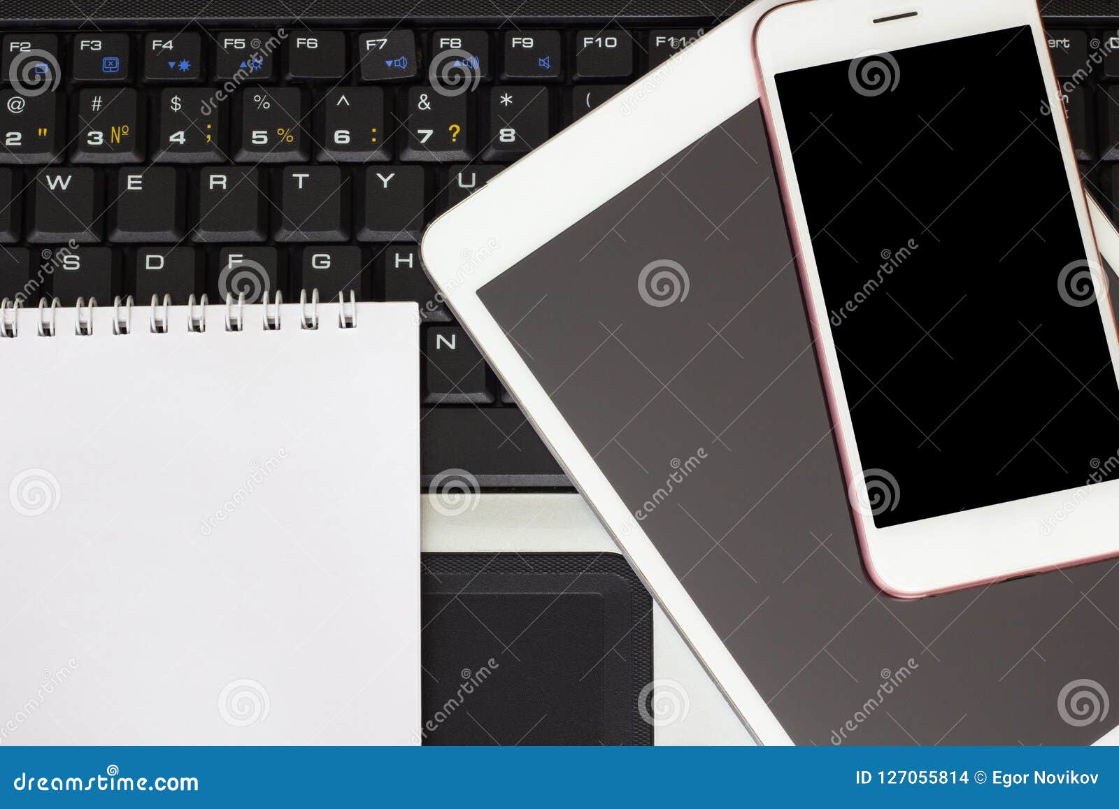 Notepad, Smartphone and Tablet on the Laptop Keyboard, Business Concept ...