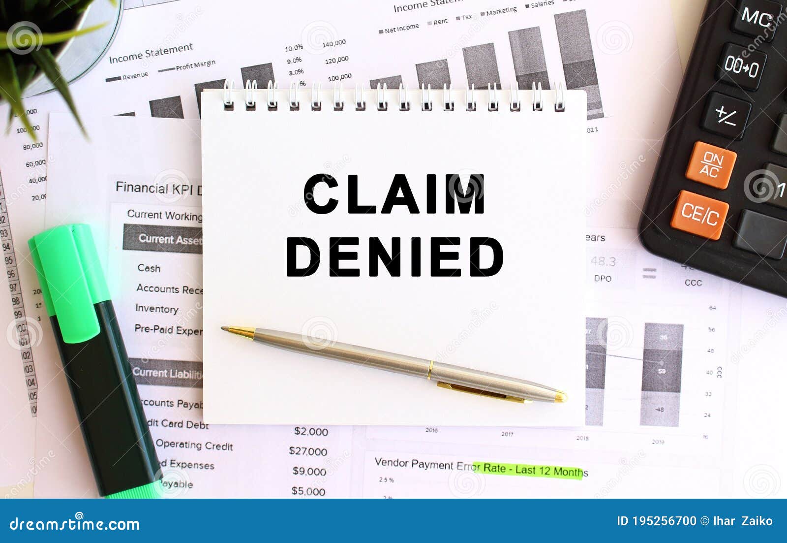 Notepad with Text CLAIM DENIED on a White Background, Near Calculator ... Notepad with Text CLAIM DENIED on a White Background, Near Calculator ...
