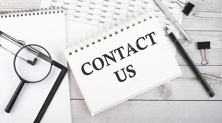 Notepad with Text CONTACT US with a Pen,office Tools and Graphs on the ...