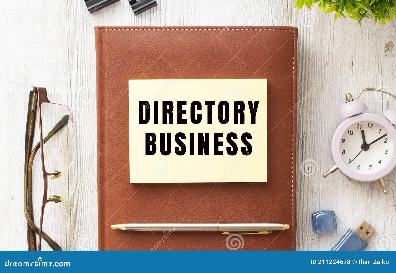 Notepad with the Text DIRECTORY BUSINESS on a Wooden Table. Brown Diary ...