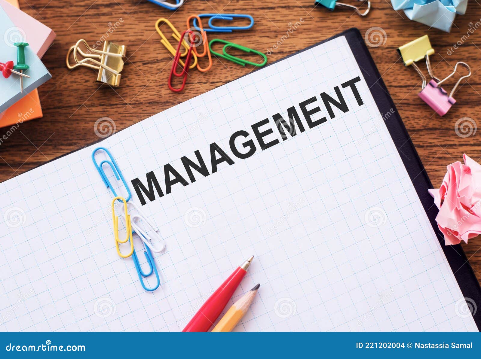 Notepad with the Text MANAGEMENT on the Table with Colored Paper Clips ...