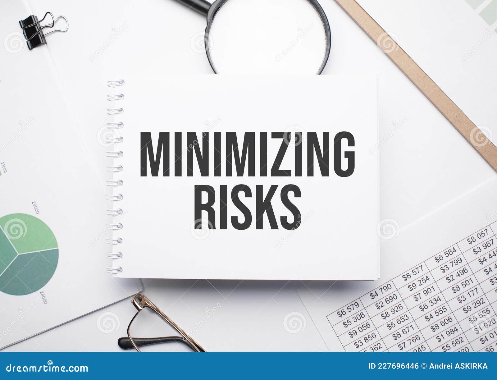 On the Notepad for Writing the Text Minimizing Risks, Magnifier,charts ...