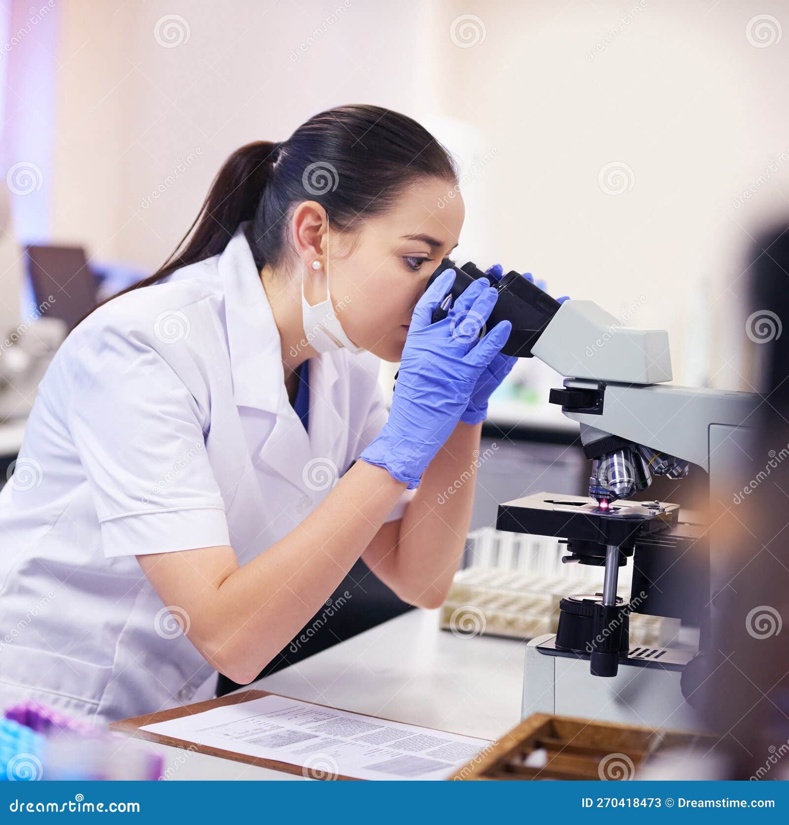 Nothing Escapes Her Eye. a Young Scientist Using a Microscope in a ...