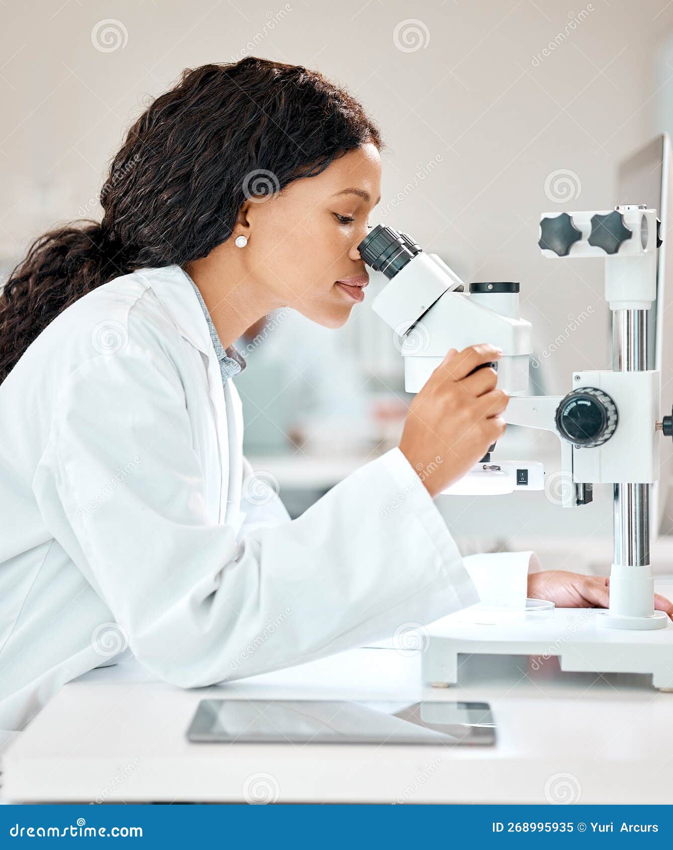 Nothing is Too Small To See. a Young Scientist Using a Microscope in a ...