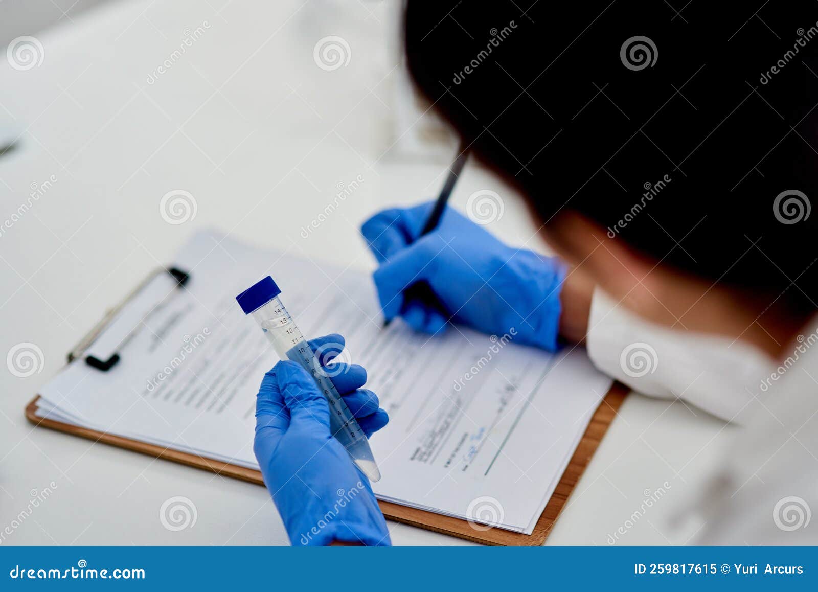 Noting Down the Correct Quantities for Her Tests. Closeup Shot of an ...