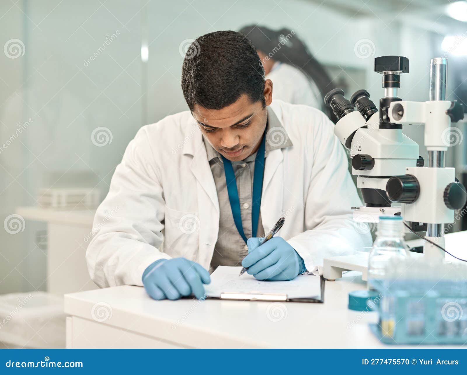 Noting Down Some Important Details from His Investigation. a Young ...