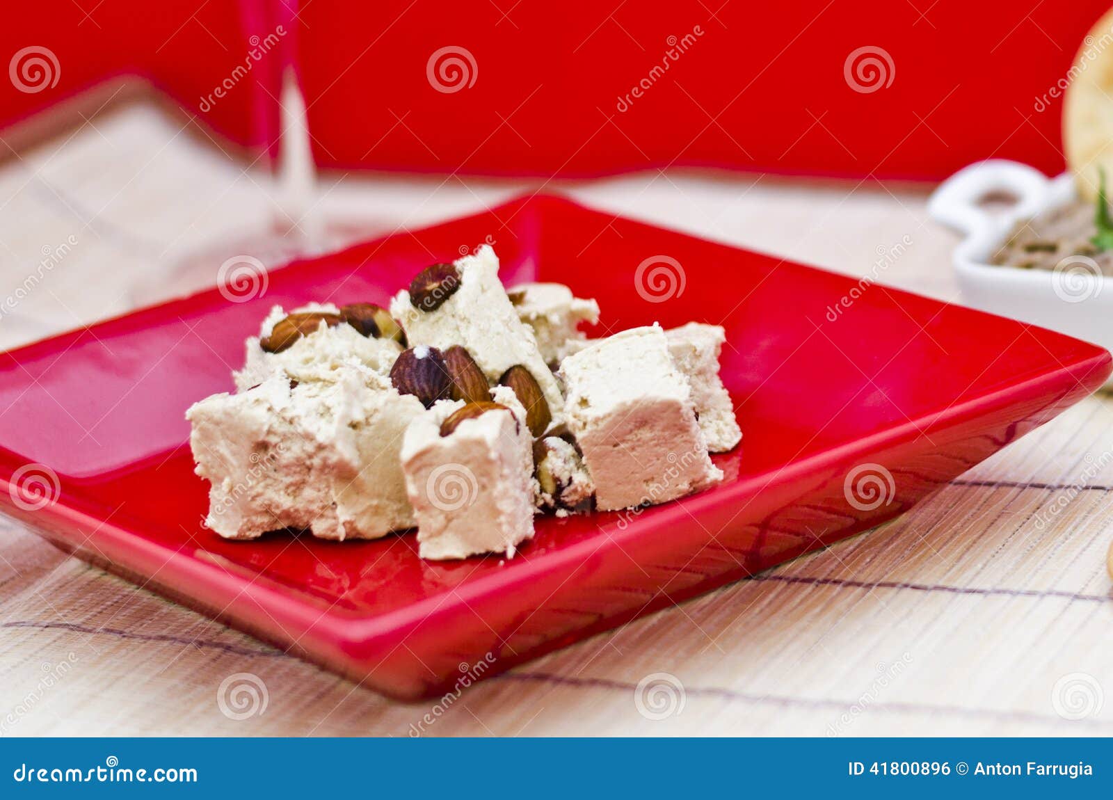 Nougat with Nuts on a Red Plate Stock Photo - Image of nuts, plate ...