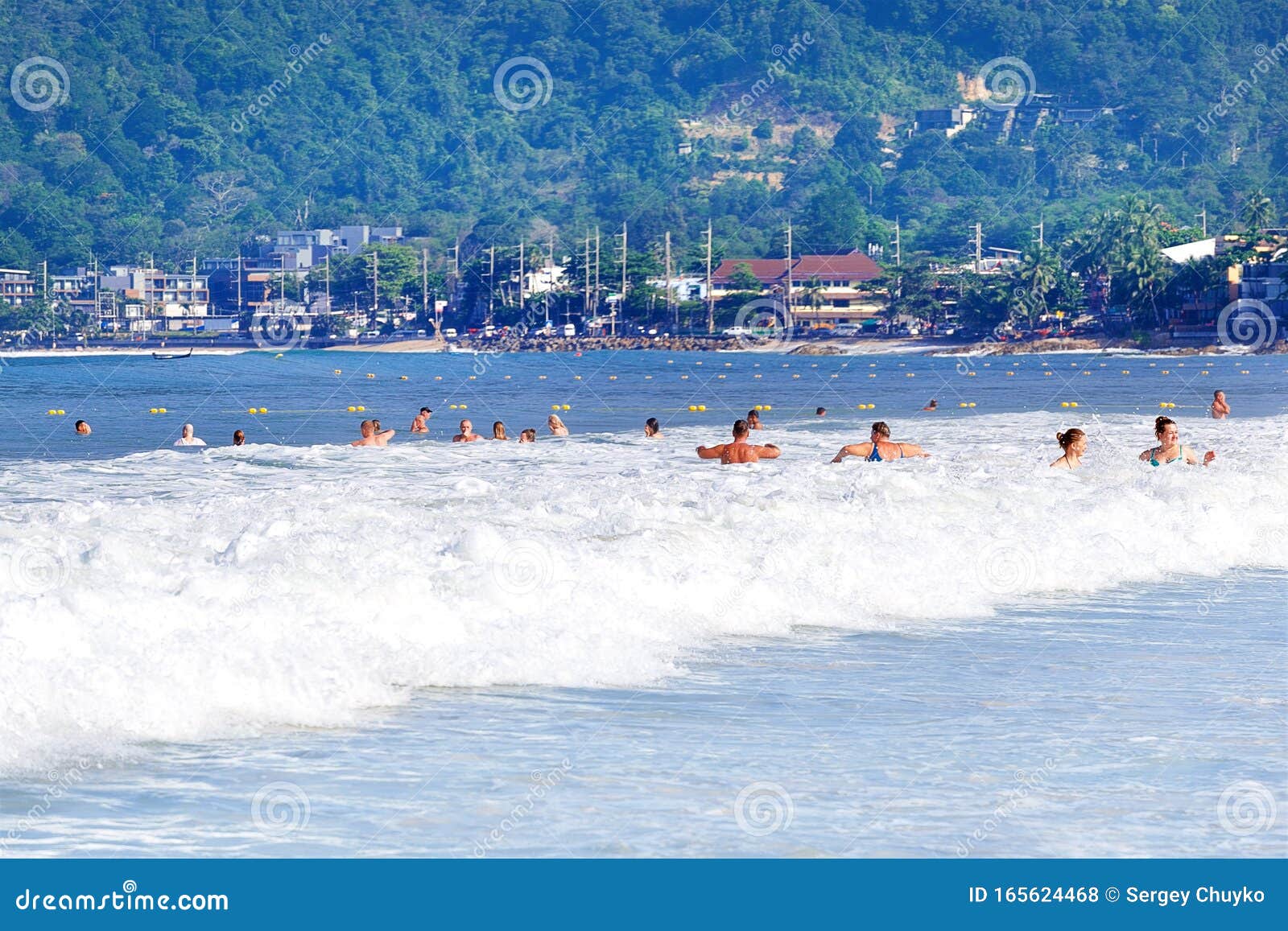 People Having Fun on the Beach while Getting Splashed by the Big Sea ...