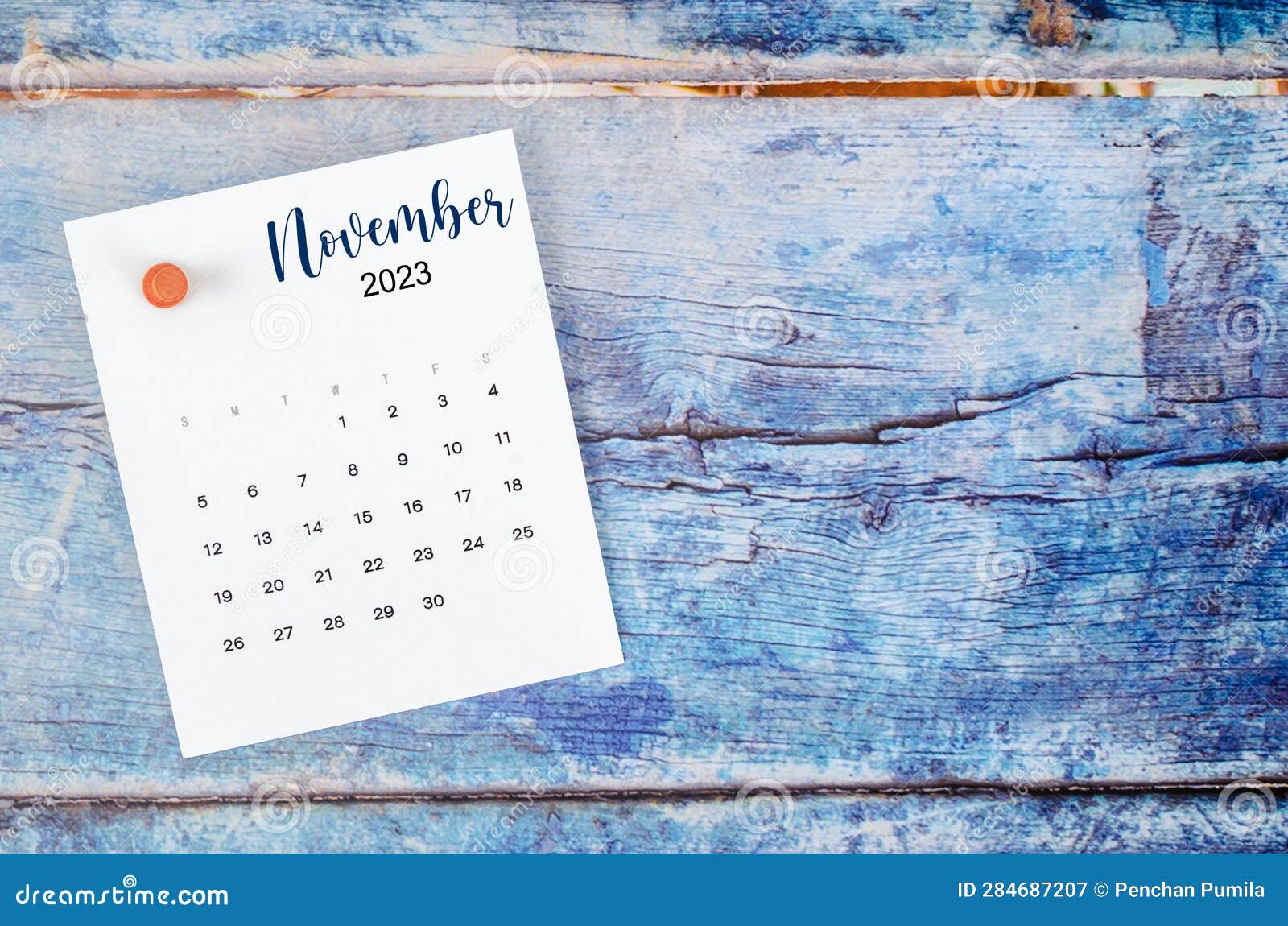 The November 2023 and Wooden Push Pin on Blue Wooden Background Stock ...