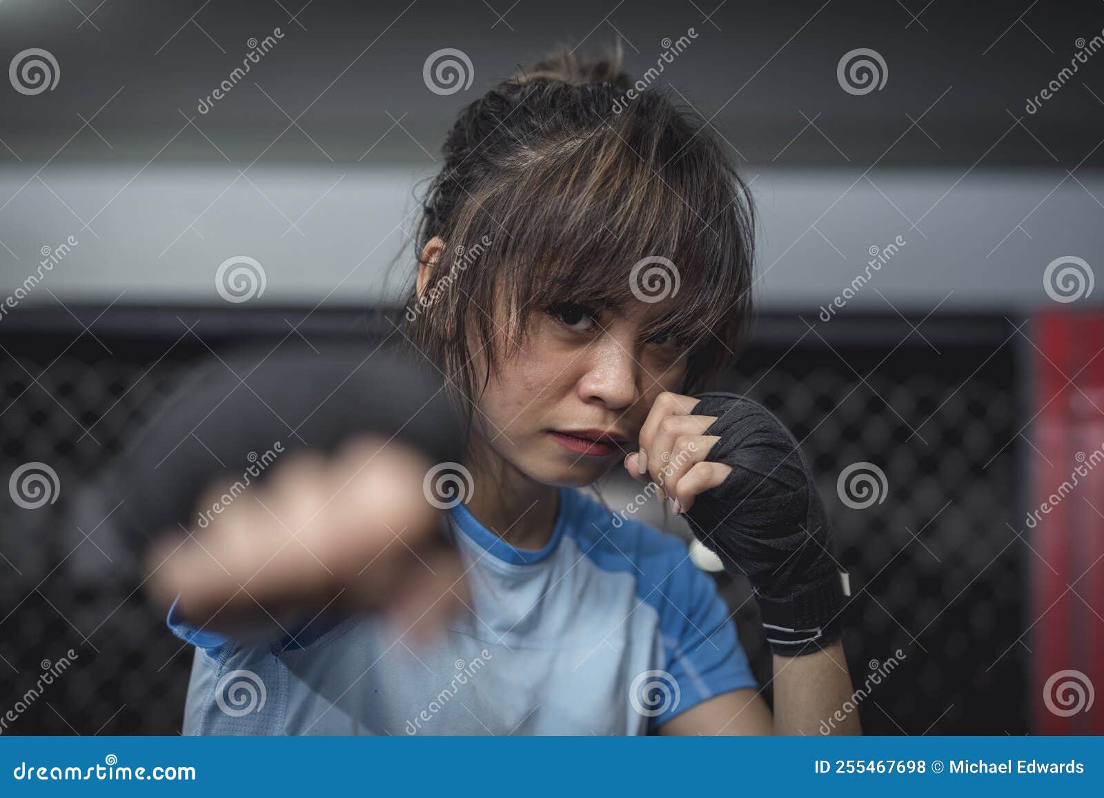 A Novice Muay Thai Trainee Poses for the Camera As she Shows the ...