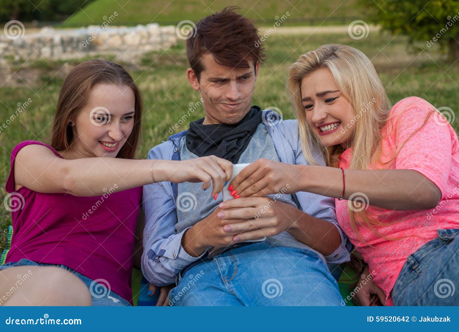 Now My Turn! Three Friends Fighting for a Mobile Phone. Stock Photo ...