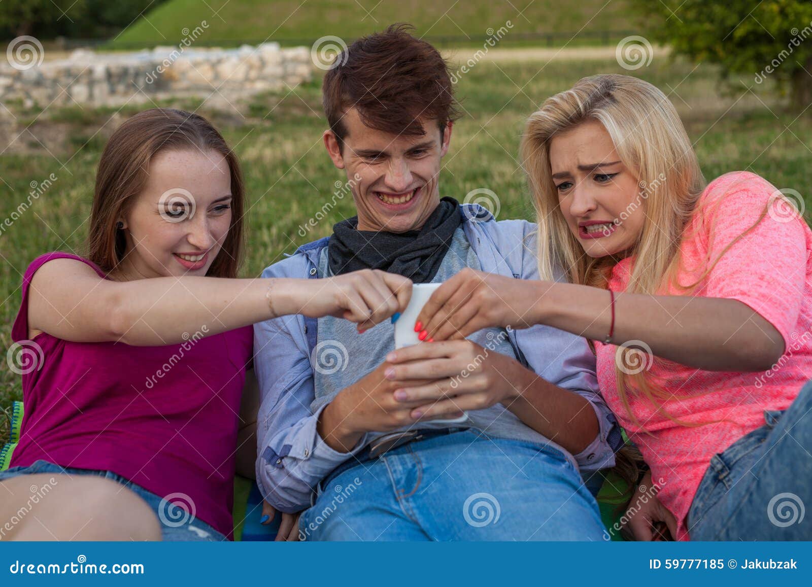 Now My Turn! Three Friends Fighting for a Mobile Phone. Stock Image ...