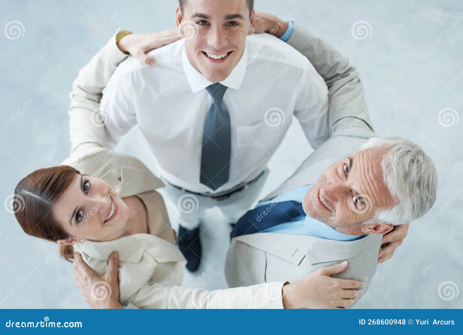 Now this is Total Teamwork. a Group of Business People Huddled Together ...