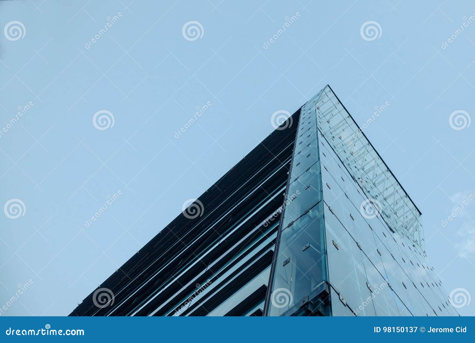 Corner of a Skyscraper Under a Cloudy and Cold Sky Seen from the Bottom ...