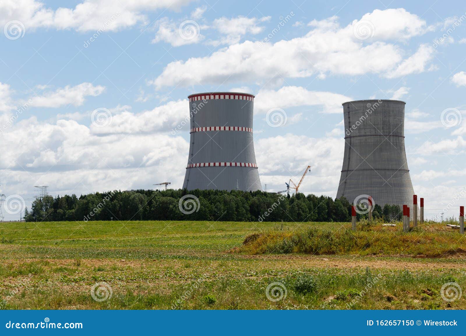 Nuclear Factory in a Grassy Field with a Cloudy Sky in the Background ...