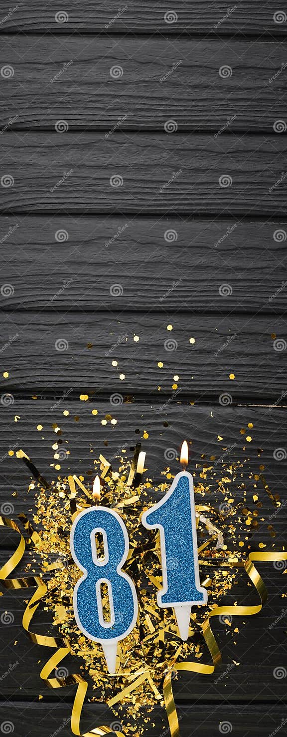 Number 81 Blue Celebration Candle And Gold Confetti On Dark Wooden
