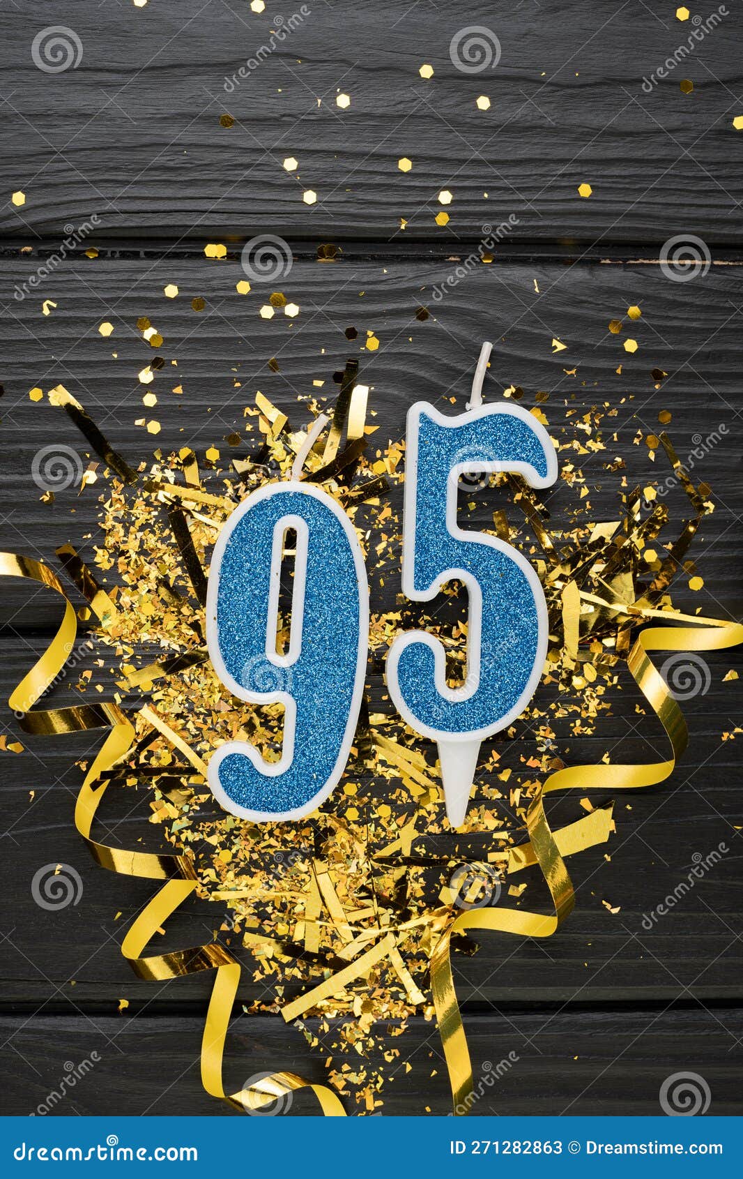 Number 95 Blue Celebration Candle And Gold Confetti On Dark Wooden
