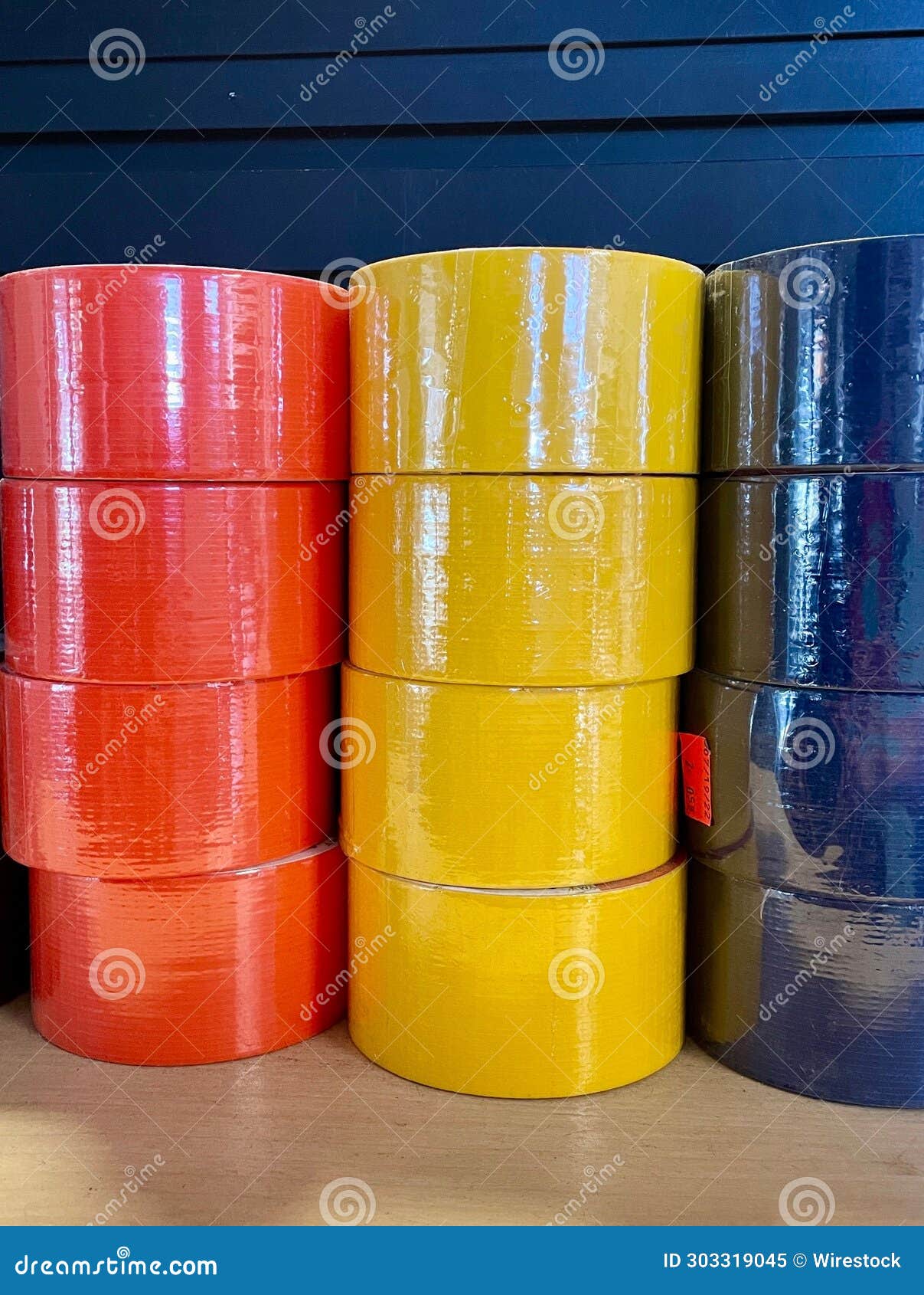 A Number of Different Colored Packaging Tape on a Shelf Above a Black ...
