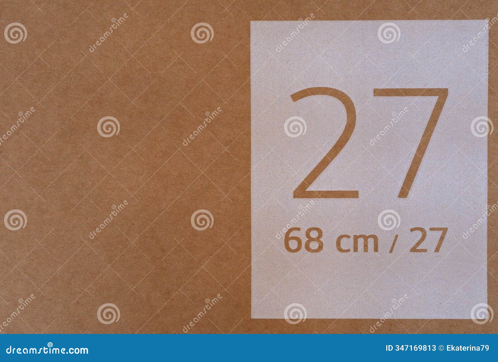 Number 27 (inches) in White Rectangle on a Cardboard Background Stock ...