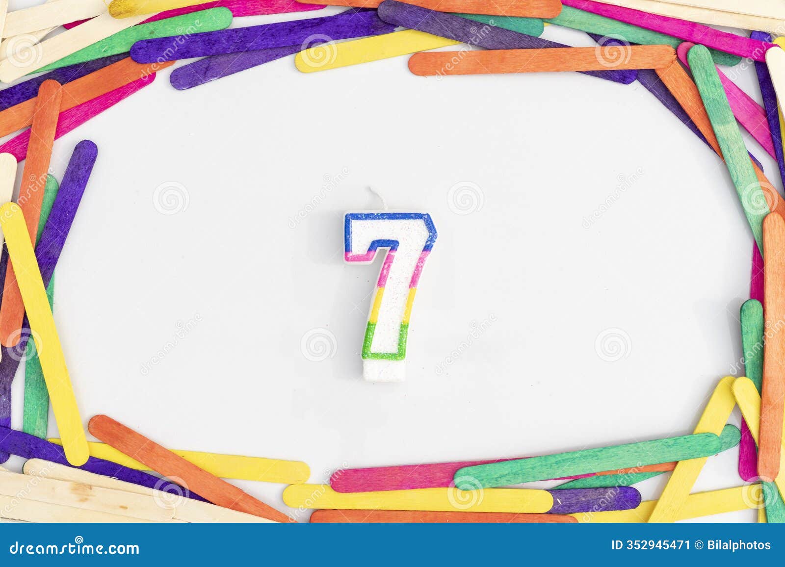 Number 7 Shape Candle with a Frame of Colorful Sticks on White Isolated ...