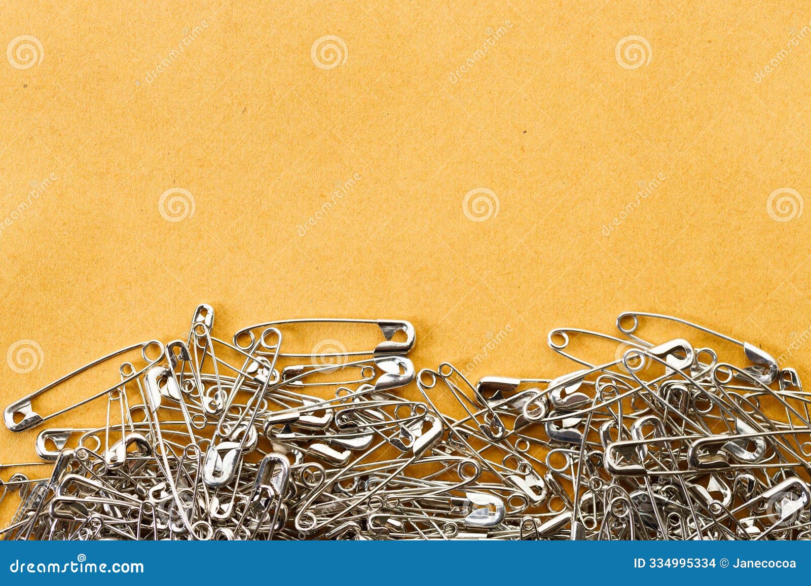 A Number of Stainless Safety Pins on Brown Paper Background Stock Photo ...