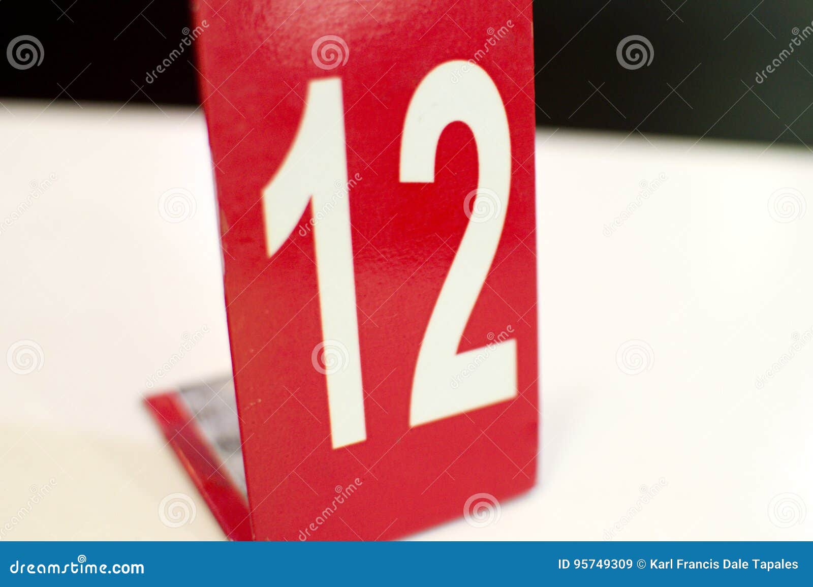 A Number Twelve Printed in White with Red Background Stock Image ...