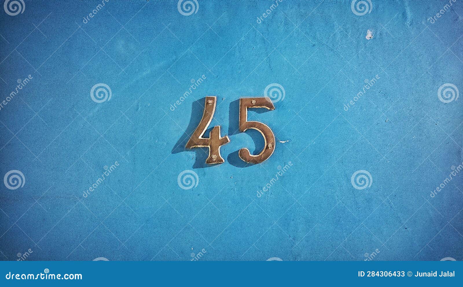 The Number 45 on the Wall on a Blue Background Stock Image - Image of ...