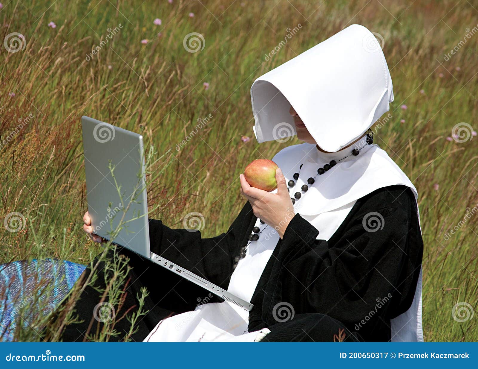 Nun on the field. stock image. Image of eating, bench - 200650317